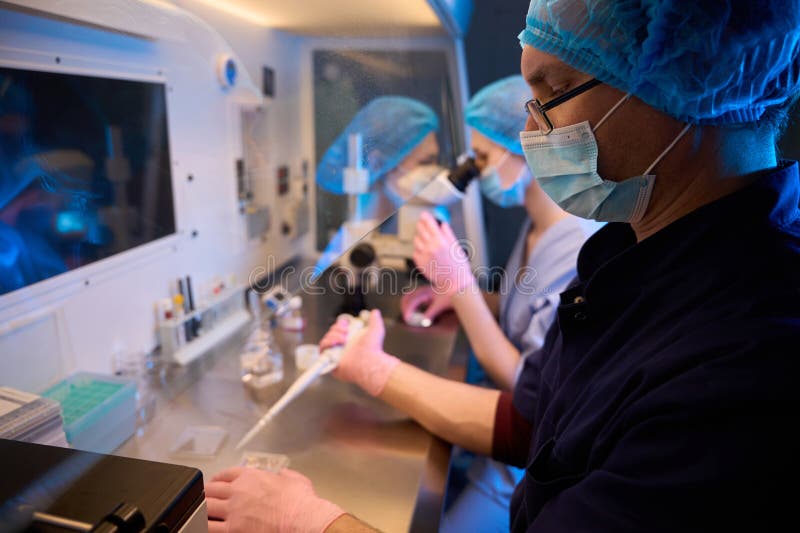Doctors Collaborating on a Procedure in a Sterile Lab Environment Stock ...