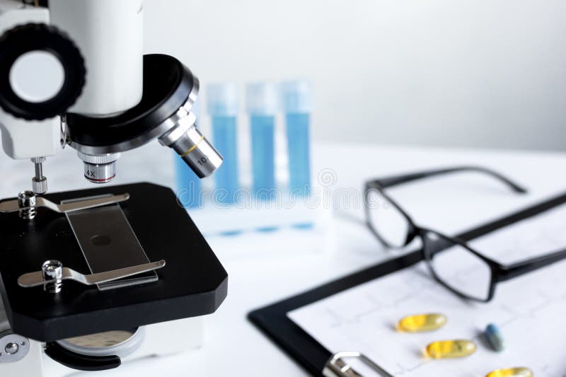 Doctors Desk with Microscope and Test Tubes Stock Photo - Image of ...