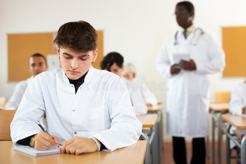 Doctors Different Age Sitting at Desk in Classroom Working during ...