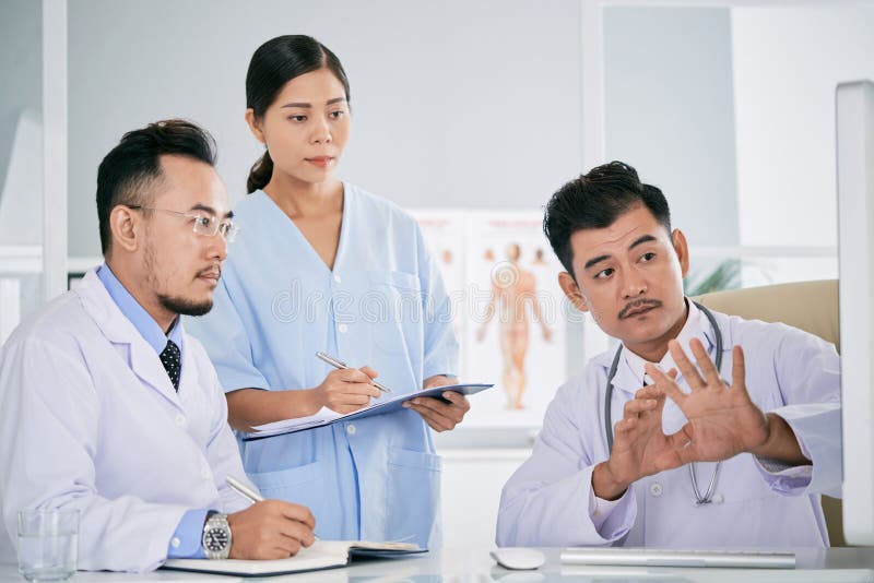Medical Workers Discussing Difficult Case Stock Photos - Free & Royalty ...