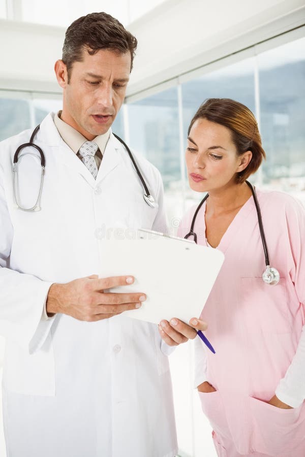 Doctors Discussing Reports at Medical Office Stock Image - Image of ...