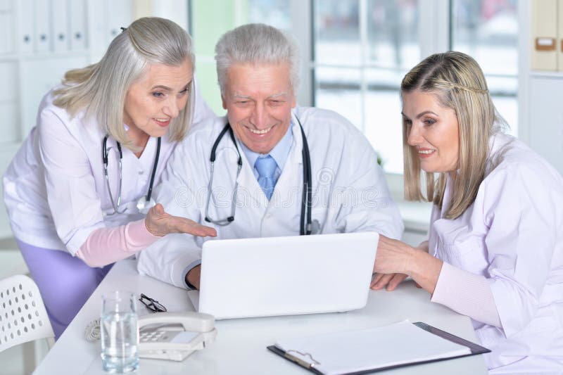 Doctors Discussing Something Stock Image - Image of health, cabinet ...