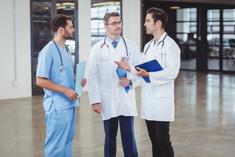 Doctors Discussing while Standing Stock Image - Image of coat, indoors ...