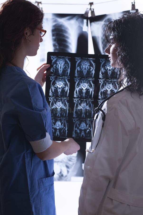 Doctors examine x-rays stock photo. Image of business - 24682402