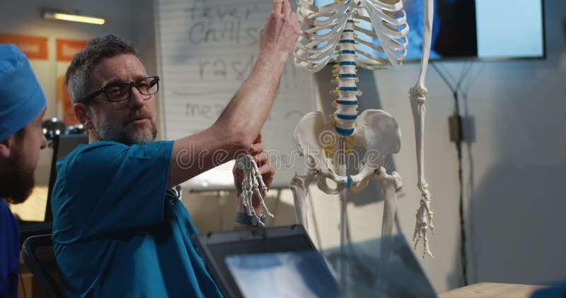 Two Doctors Examining Young Patient. Female Doctor Checking His ...
