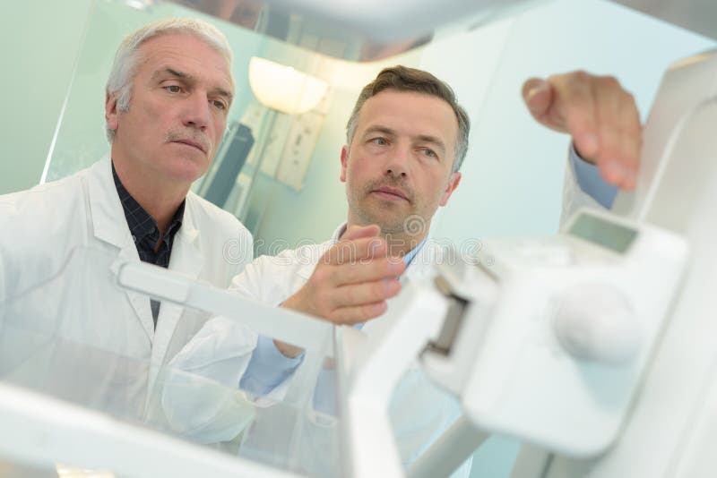 Doctors Examining the Machine Stock Image - Image of hospital ...