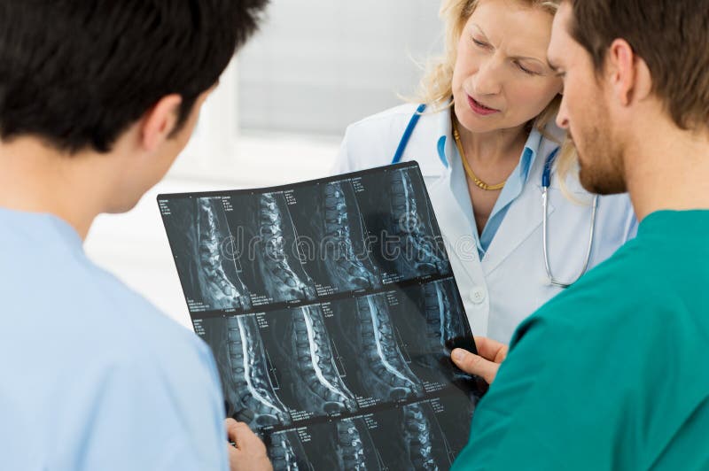Team of Doctors Examining Reports Stock Photo - Image of discussing ... Team of Doctors Examining Reports Stock Photo - Image of discussing ...