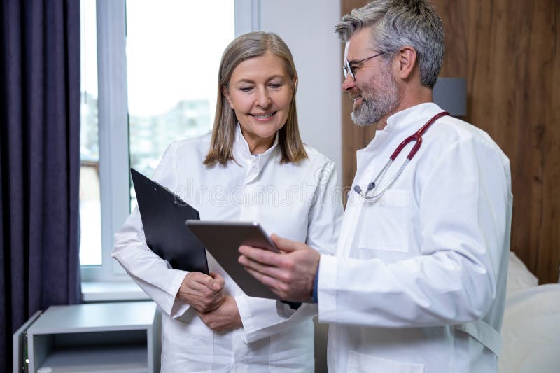 Doctors Having a Changeover in a Clinic and Sharing Information Stock ...