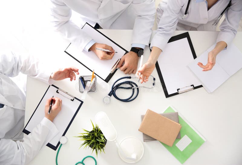 Doctors Having Meeting at Table in Office Stock Photo - Image of ...