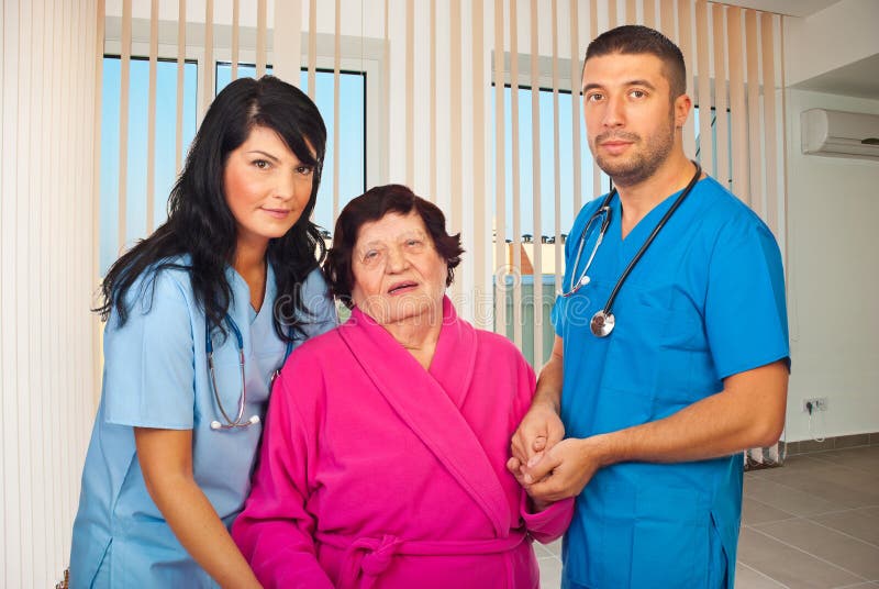 Doctors Helping Elderly Woman Patient Stock Photo - Image of help ...