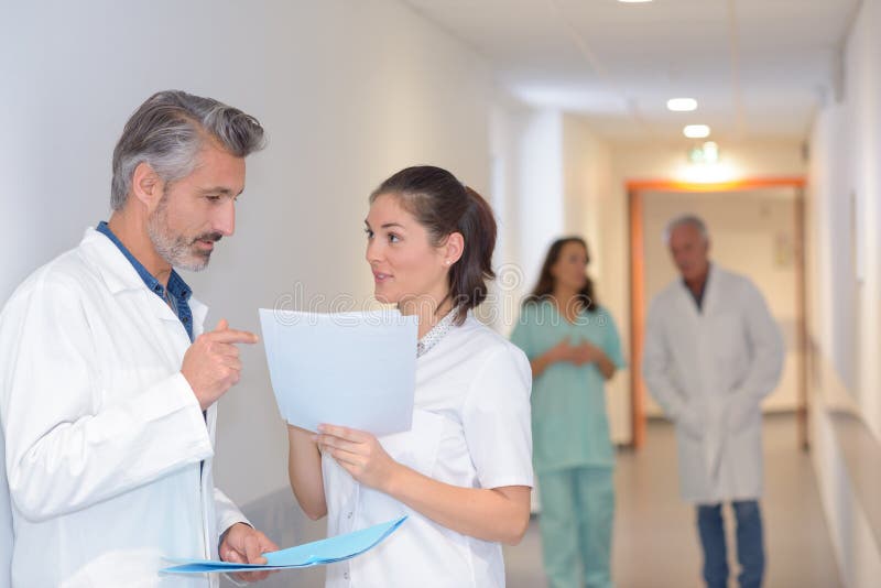 Doctors Holding Emergency Papers Stock Image - Image of secretary ...