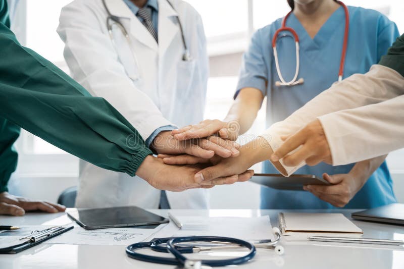 Doctors Holding Hands Together at Hospital Stock Image - Image of ...
