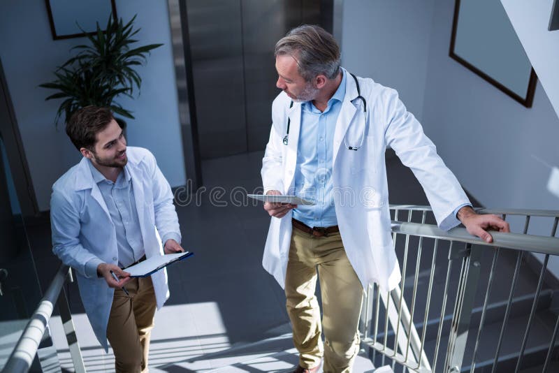 Doctors Interacting with Each Other on Staircase Stock Photo - Image of ...