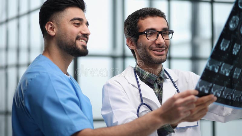 Two Male Doctors Looking at Brain X-ray Stock Image - Image of ...