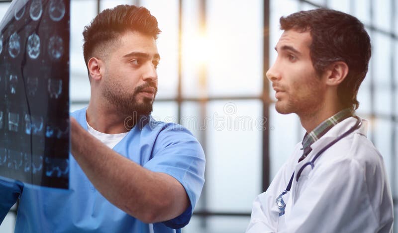 Two Male Doctors Looking at Brain X-ray Stock Image - Image of ...