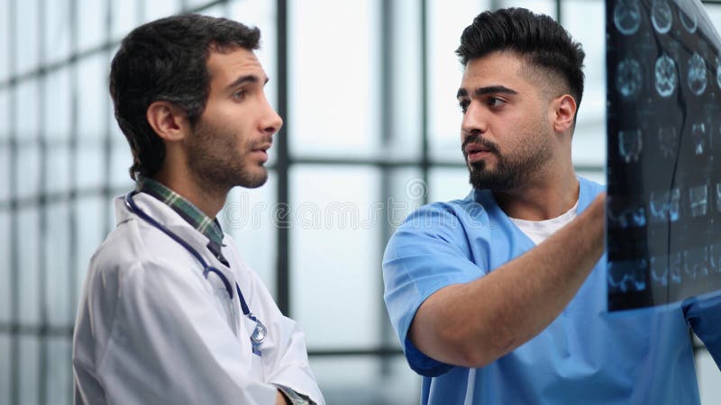 Two Male Doctors Looking at Brain X-ray Stock Image - Image of ...