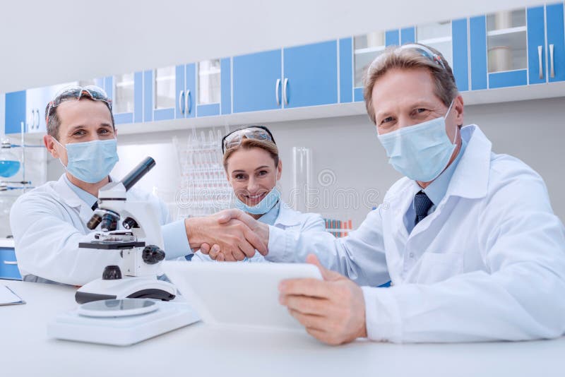 Scientists shaking hands stock photo. Image of people - 105862486