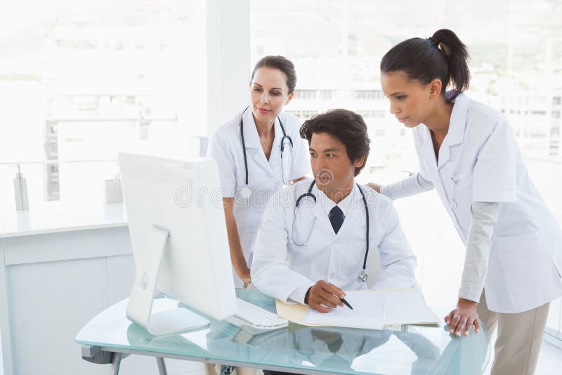Doctors Looking at a Computer Stock Image - Image of arms, hospital ...