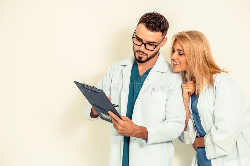 Doctors Looking and Discussing on Documents Paper. Stock Image - Image ...