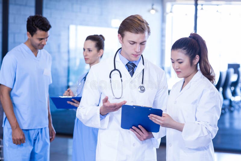 Doctors Looking at Medical Report Stock Image - Image of adult ...