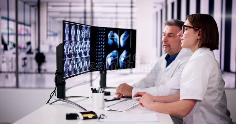 Doctors Looking at an MRI Scan at Computer Stock Image - Image of ...