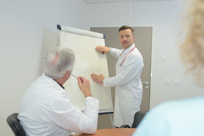 Doctors Looking at White Board in Meeting Stock Image - Image of ...