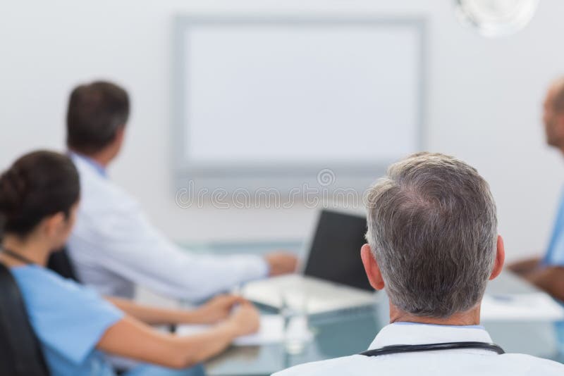 Doctors Looking at White Board Stock Photo - Image of people, office ...