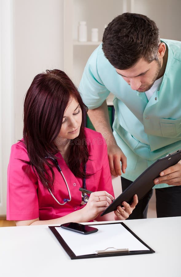 Doctors Making Medical Notes Stock Image - Image of apron, documents ...