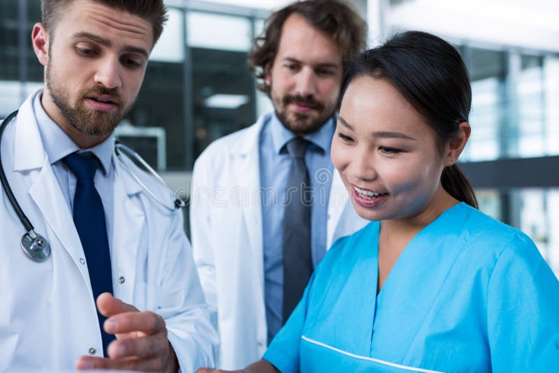 Doctors in Discussion with Patient in Medical Office Stock Image ...