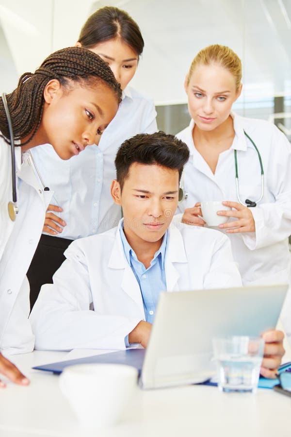 Doctors Working with Computer in Workshop Stock Photo - Image of ...