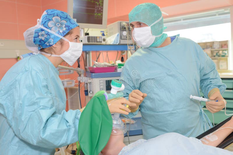 Doctors in operating room stock photo. Image of medication - 267511628