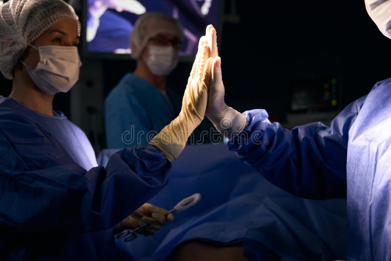 Doctors in Operating Room Give High Five after Successful Operation ...