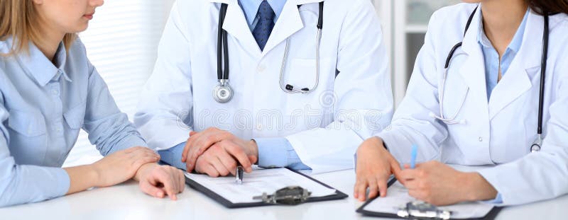 Doctors and Patient Talking while Sitting at the Table . Concept of ...