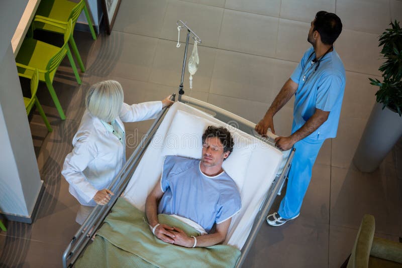 Doctors Pushing the Bed of a Patient Stock Photo - Image of staff ...