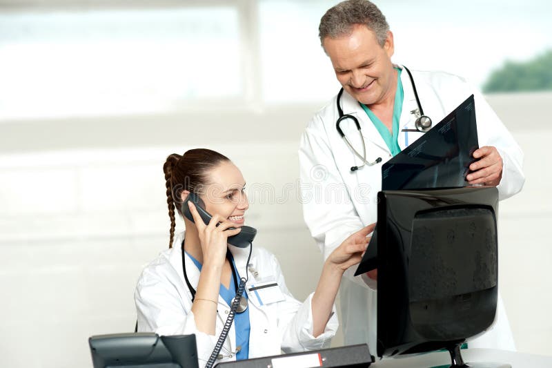 Doctors Reviewing Patients X-ray Report Stock Photo - Image of ...