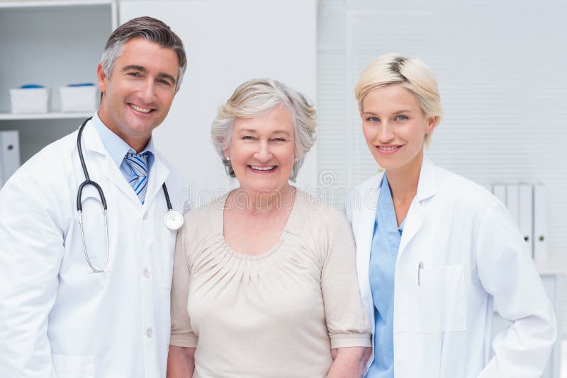 Doctors and Senior Patient Smiling in Clinic Stock Image - Image of ...