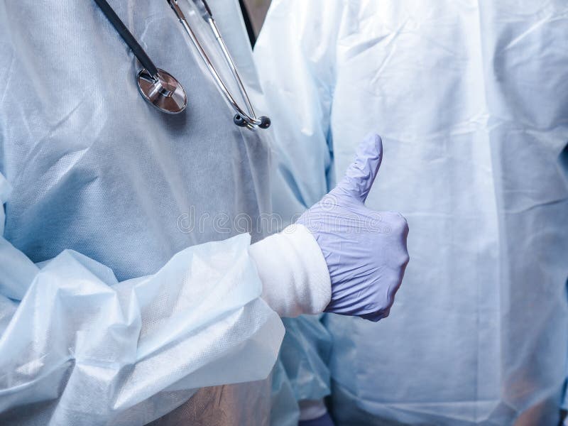 Doctors showing thumbs up stock image. Image of sterile - 176935621