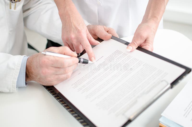 Doctors Signing a Medical Report Stock Photo - Image of writing, health ...