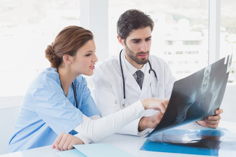 Doctors Sitting Together with X-rays Stock Image - Image of health ...