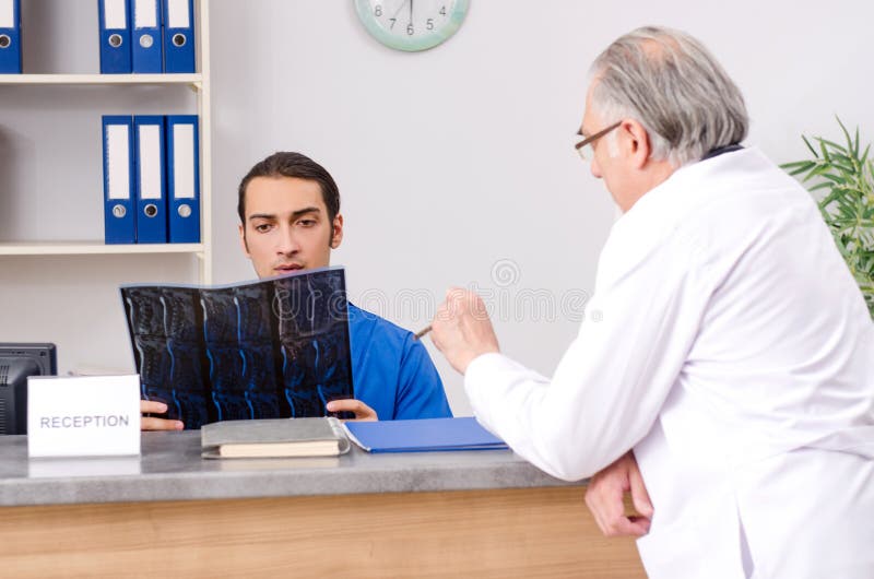 Two Doctors Talking at the Reception in Hospital Stock Photo - Image of ... Two Doctors Talking at the Reception in Hospital Stock Photo - Image of ...