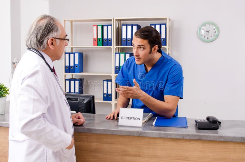 Two Doctors Talking at the Reception in Hospital Stock Photo - Image of ...
