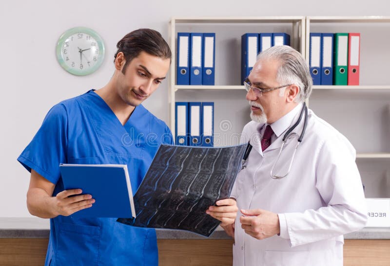 Two Doctors Talking at the Reception in Hospital Stock Image - Image of ...