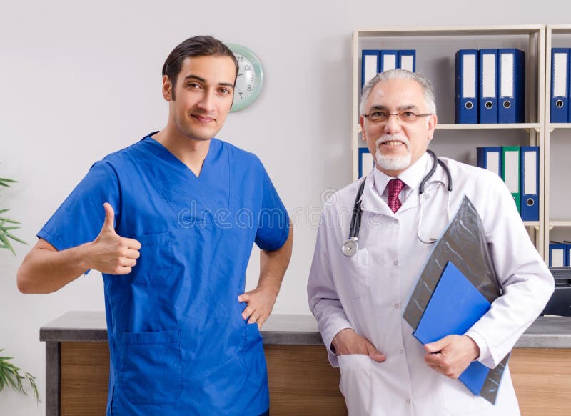 Two Doctors Talking at the Reception in Hospital Stock Photo - Image of ...