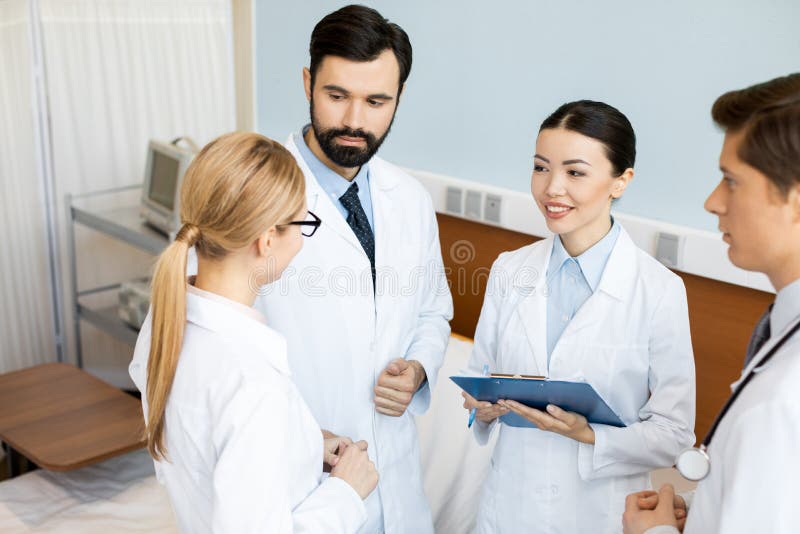 Doctors Team Discussing Diagnosis Stock Photo - Image of conversation ...