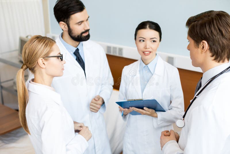 Doctors Team Discussing Diagnosis Stock Photo - Image of conversation ...