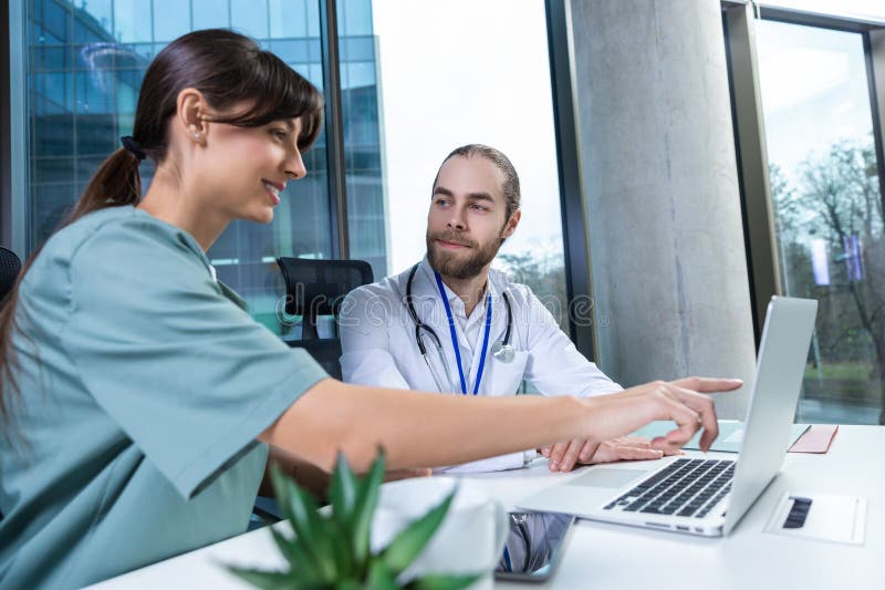 Doctors Therapists Working Discussing Patient Care and Using Computer ...