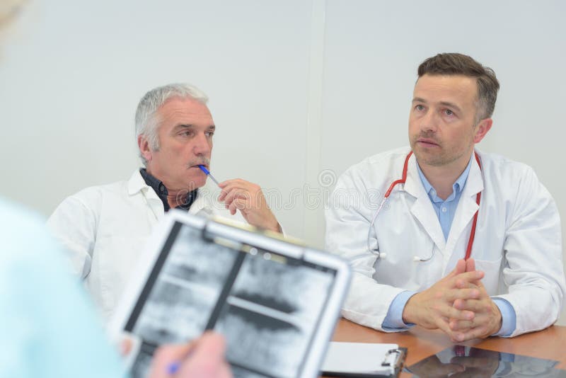 Doctors Thinking Best Decision To Treat Patient Stock Image - Image of ...