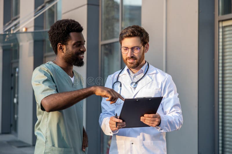 Two Doctors Discussing Patient Case and Looking Involved Stock Image ...