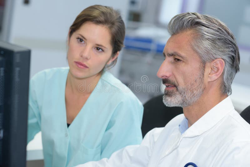 Doctors using a computer stock image. Image of doctors - 127176709