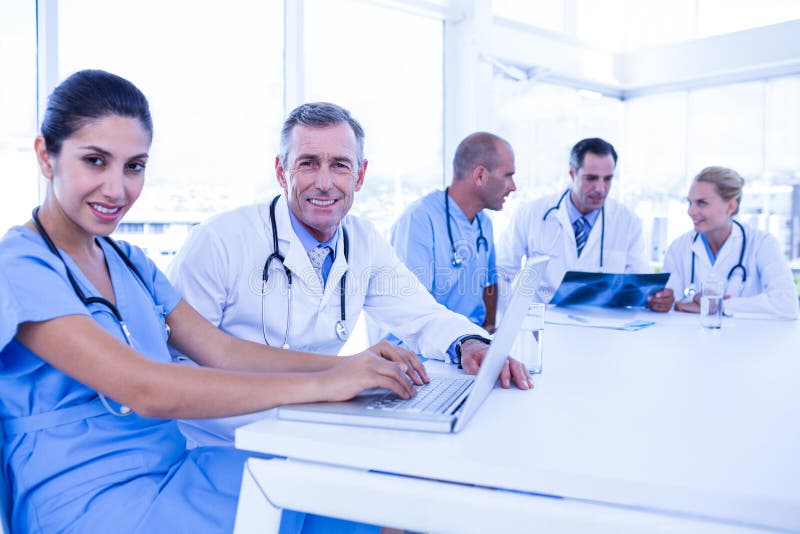 Doctors Using Computer Whiles Theirs Colleagues Looking at Xray Stock ...